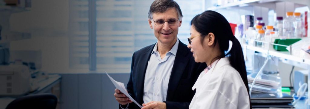 dr-benjamin-neel-talks-to-researcher-in-lab – The Neel Lab